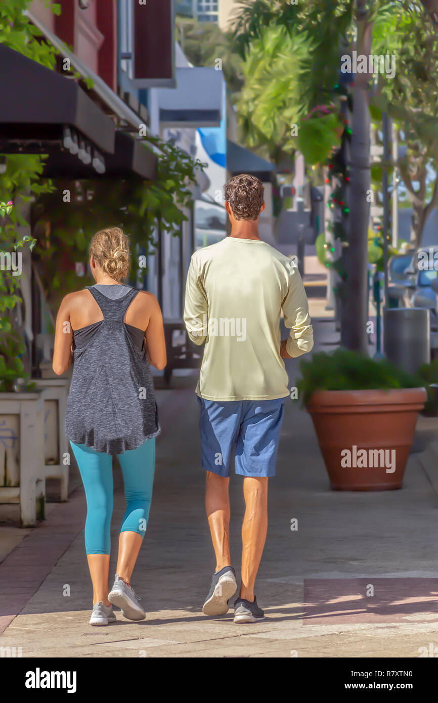 Two people are casually walking sunny street hi-res stock photography ...