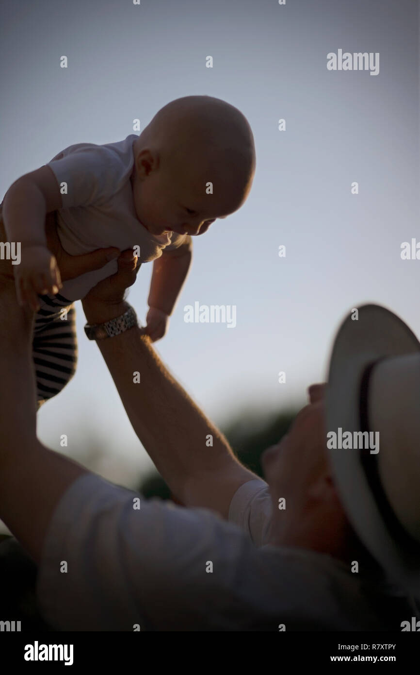 Baby held aloft hi-res stock photography and images - Alamy