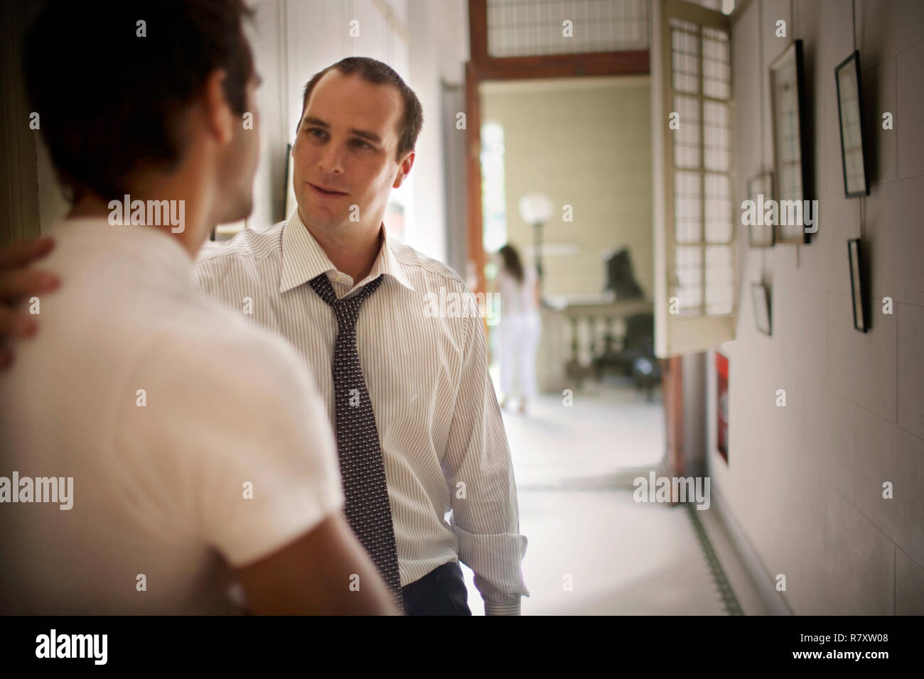 View of two men talking to each other Stock Photo - Alamy