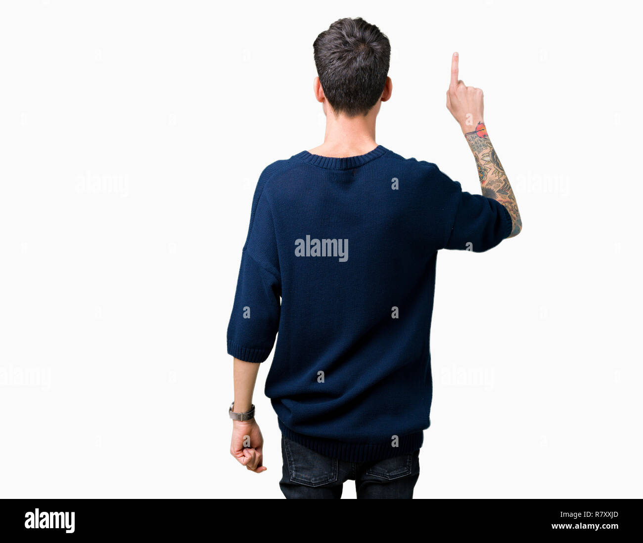 Young handsome man over isolated background Posing backwards pointing ...