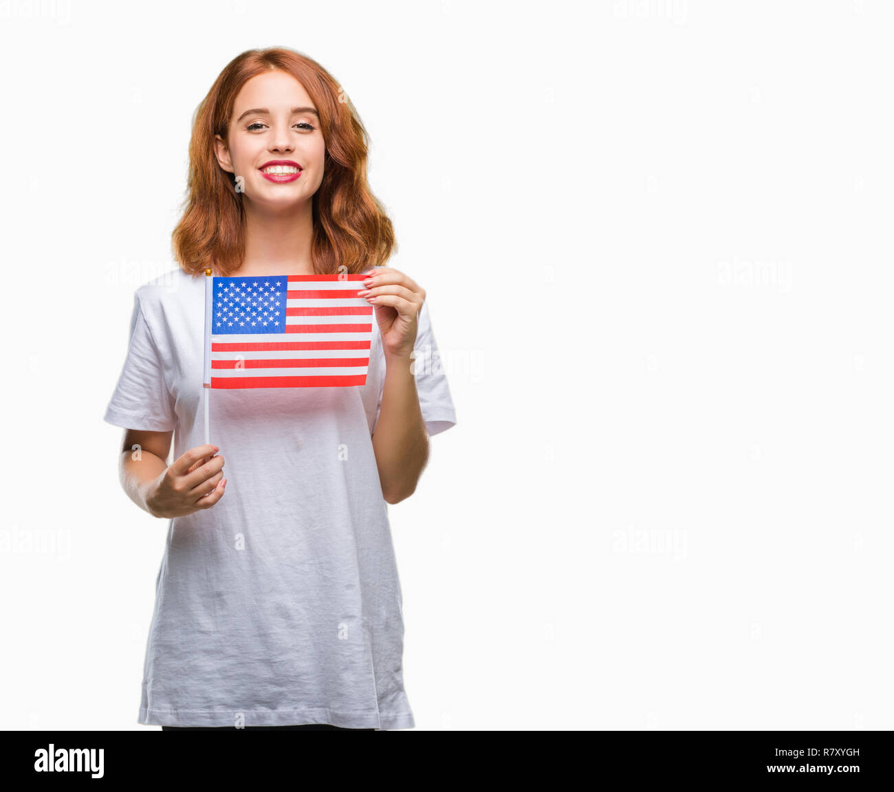 Young beautiful woman holding flag of america over isolated background ...