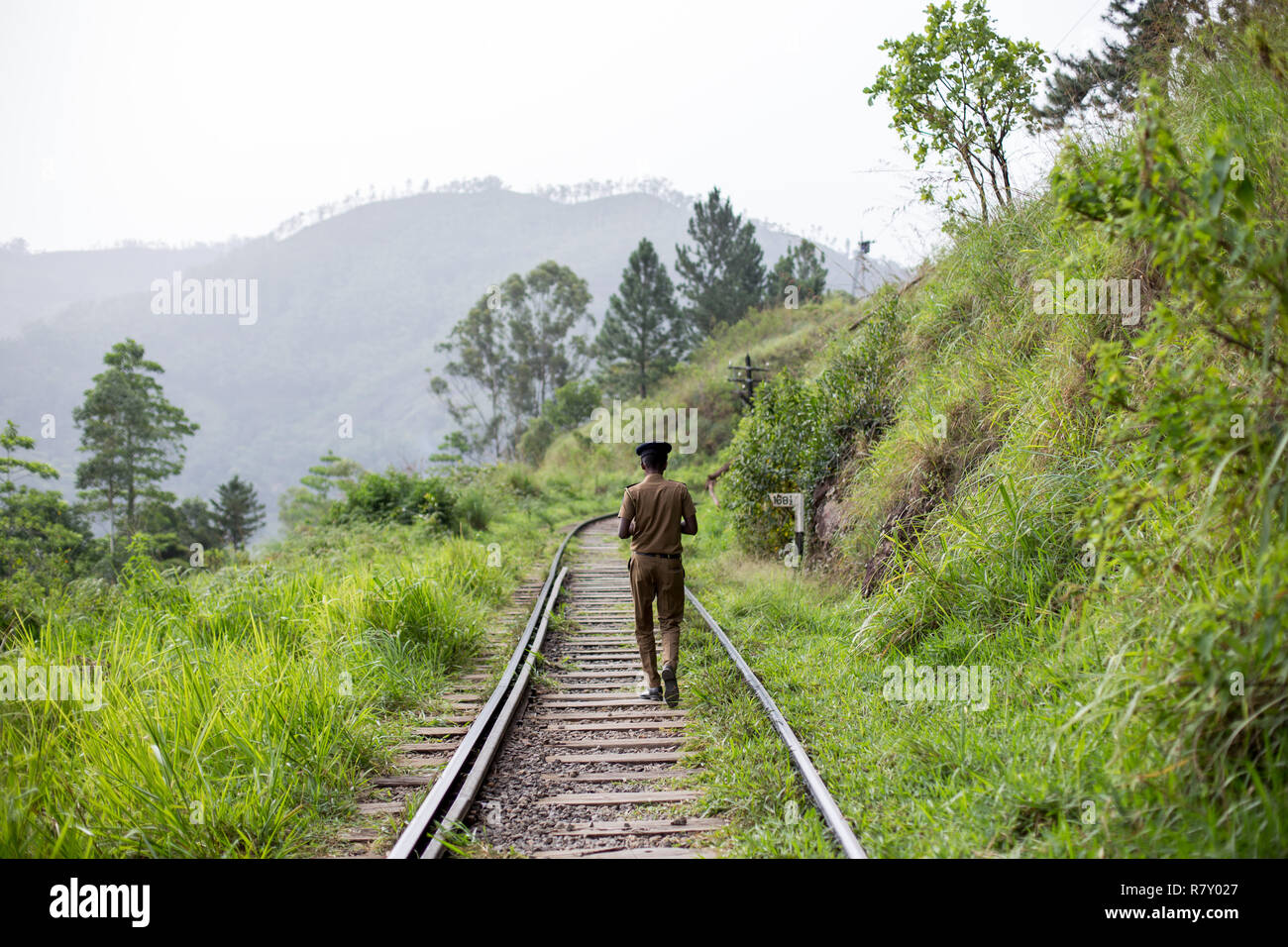 Ella, Sri Lanka - August 5, 2018: A local policeman walking on train ...