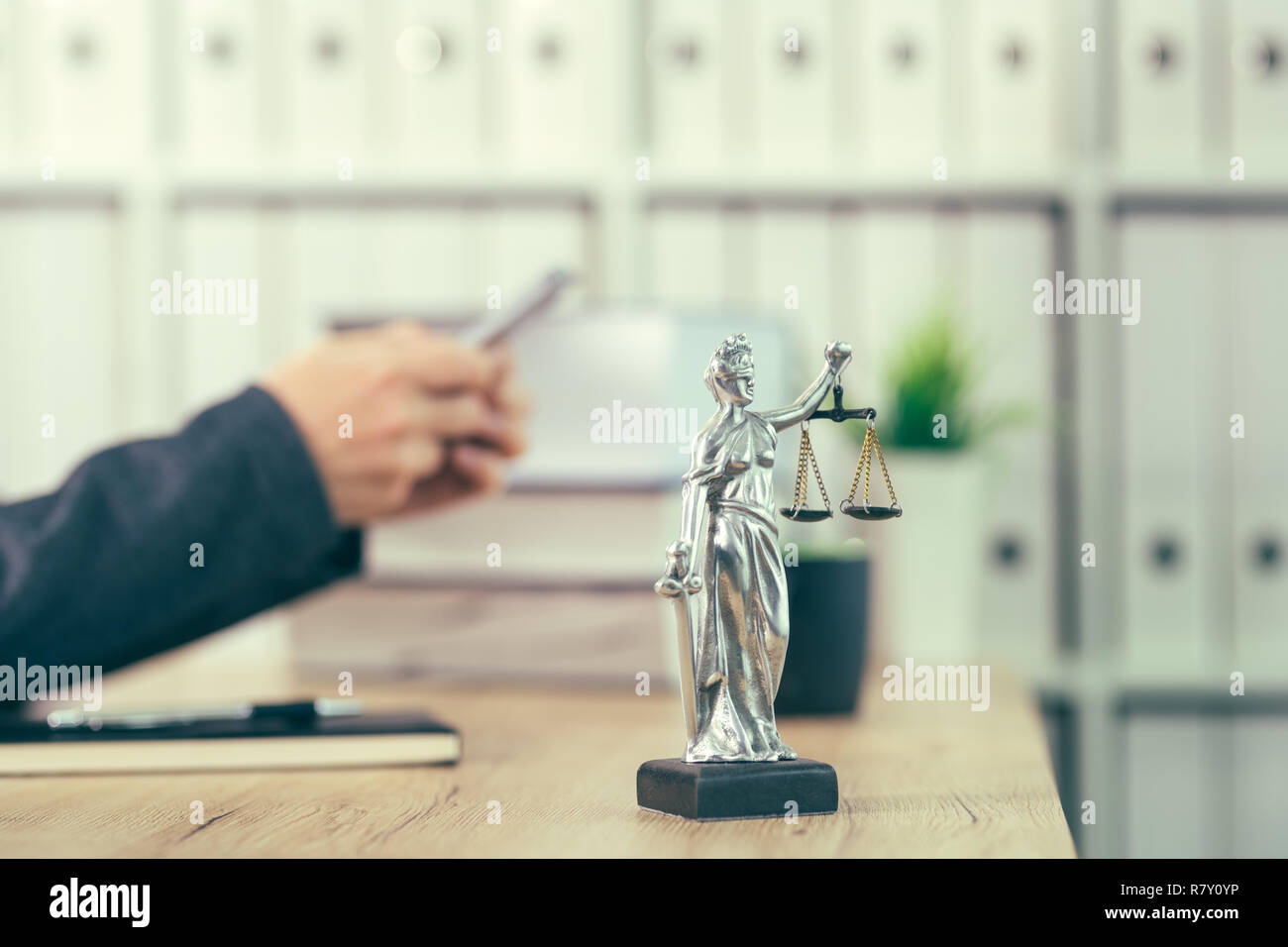Attorney woman texting on mobile phone from her office desk, selective ...