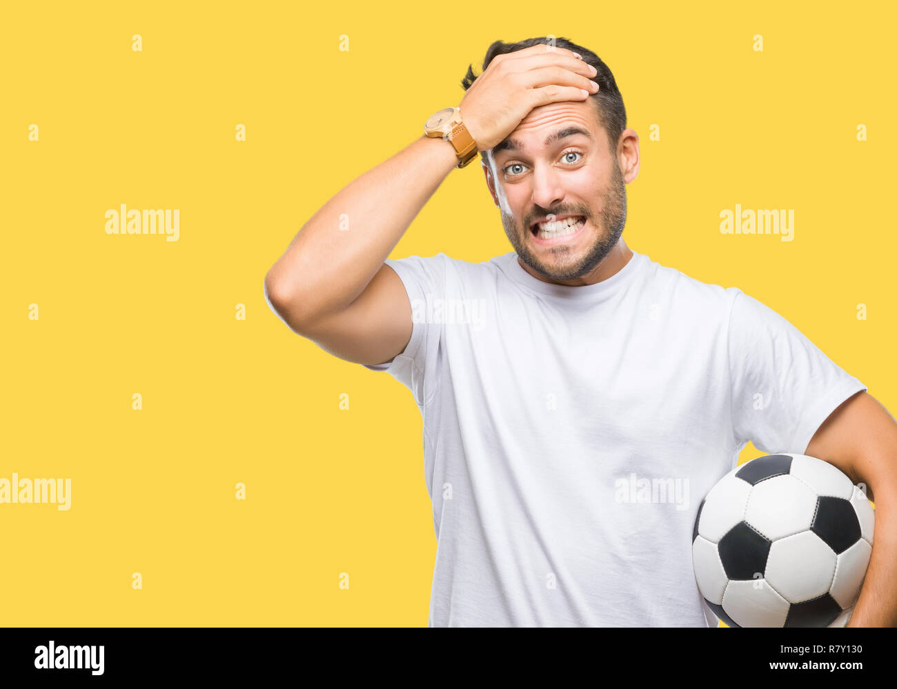Young handsome man holding soccer football ball over isolated ...