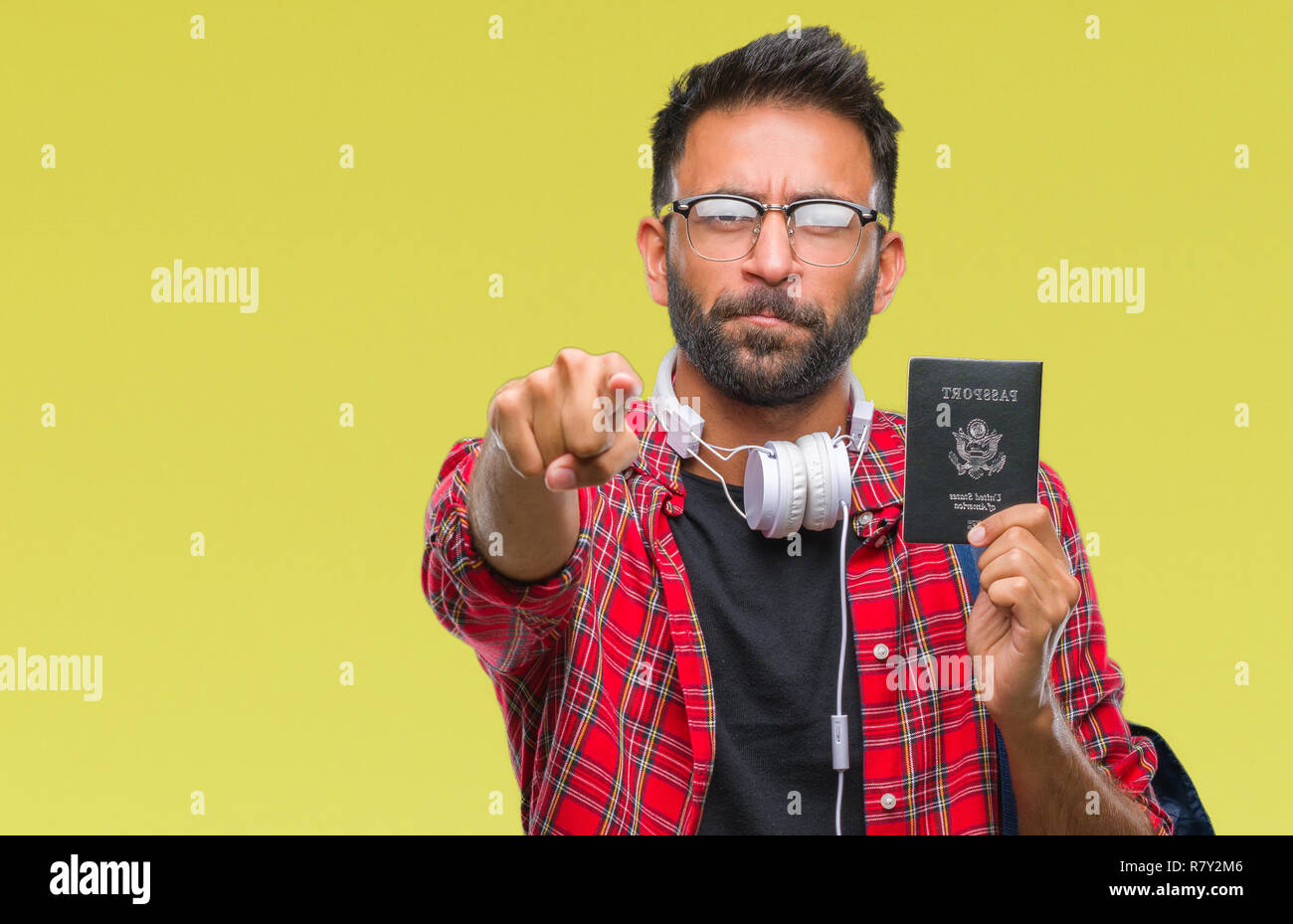 Adult hispanic student man holding passport of america over isolated ...