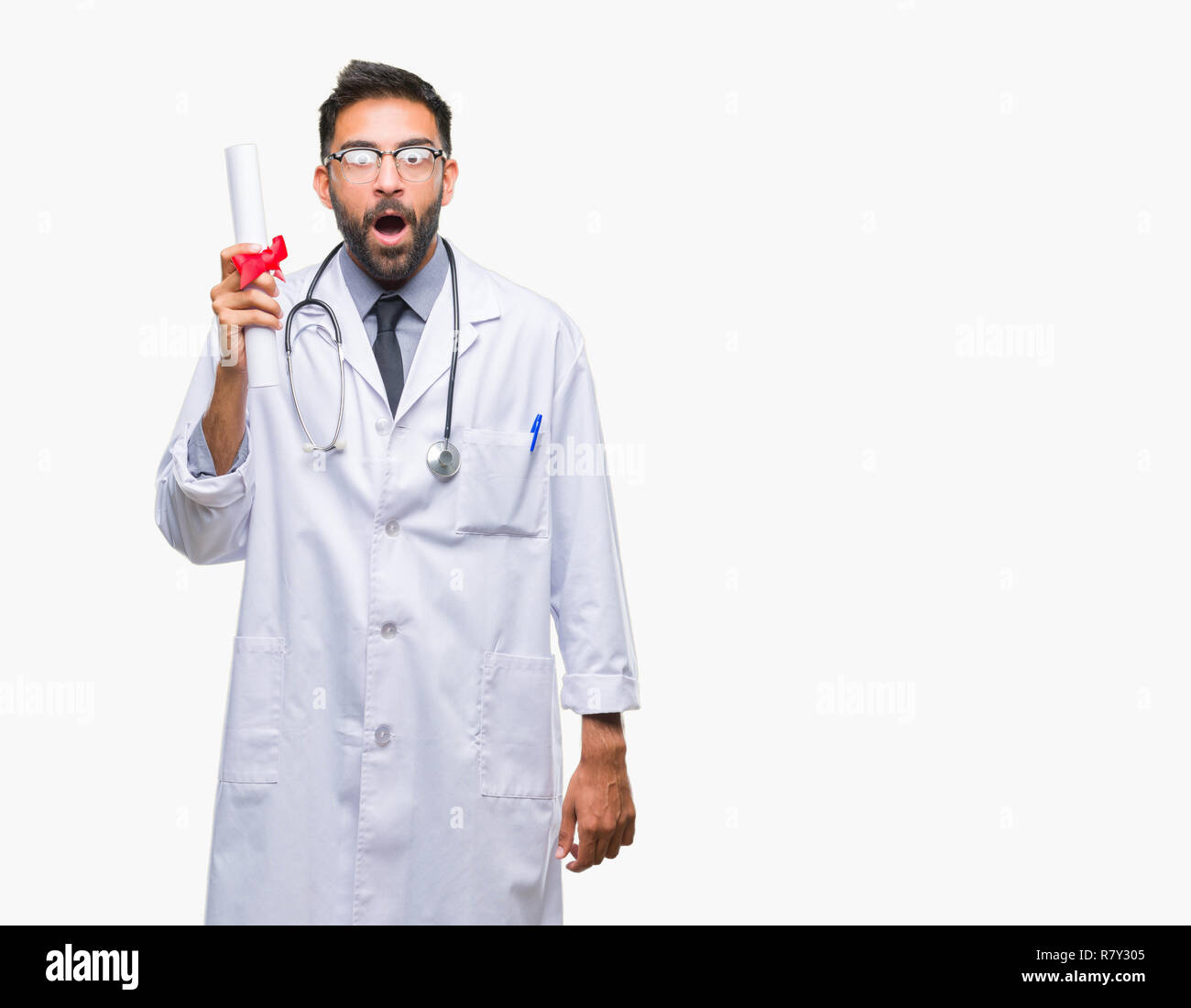 Adult hispanic doctor man holding degree over isolated background ...