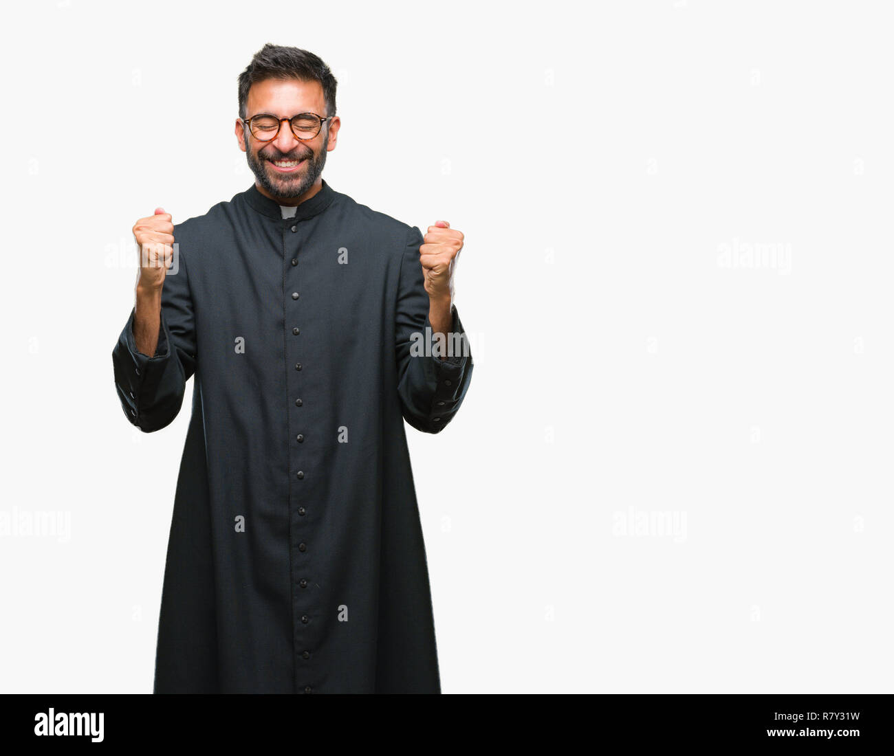 Adult hispanic catholic priest man over isolated background excited for ...