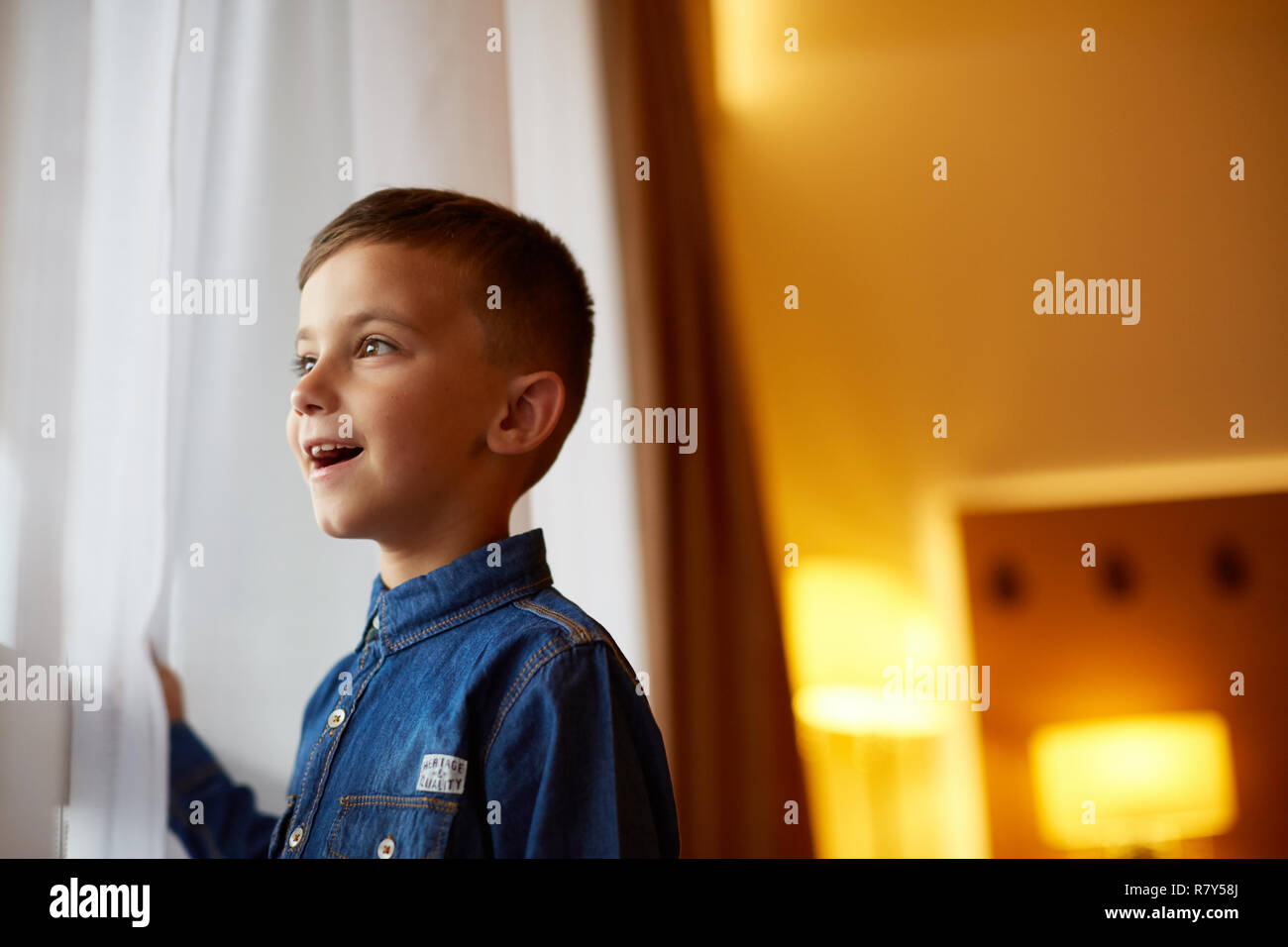 Little boy near the window indoors Stock Photo - Alamy