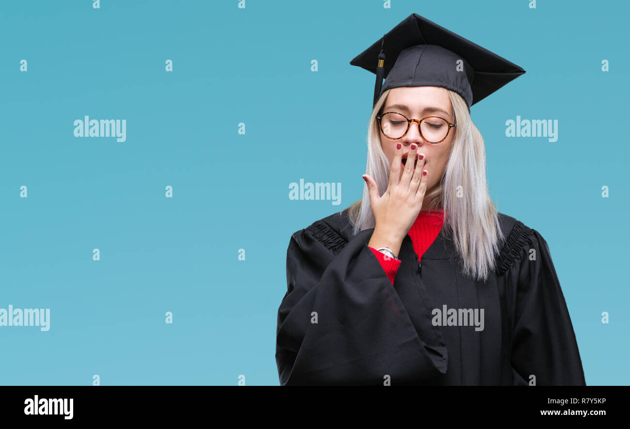 Young blonde woman wearing graduate uniform over isolated background ...