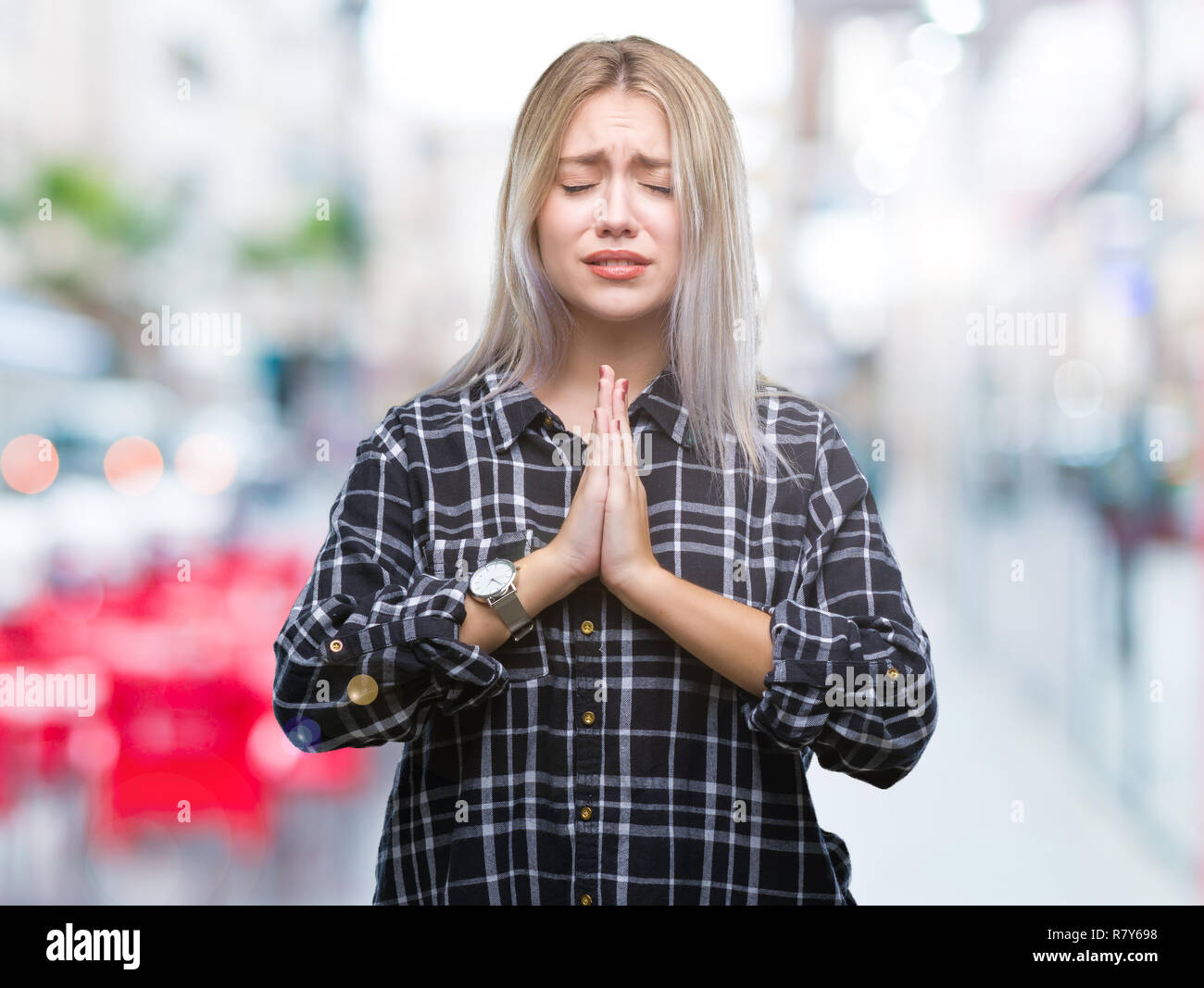 Young blonde woman over isolated background begging and praying with ...