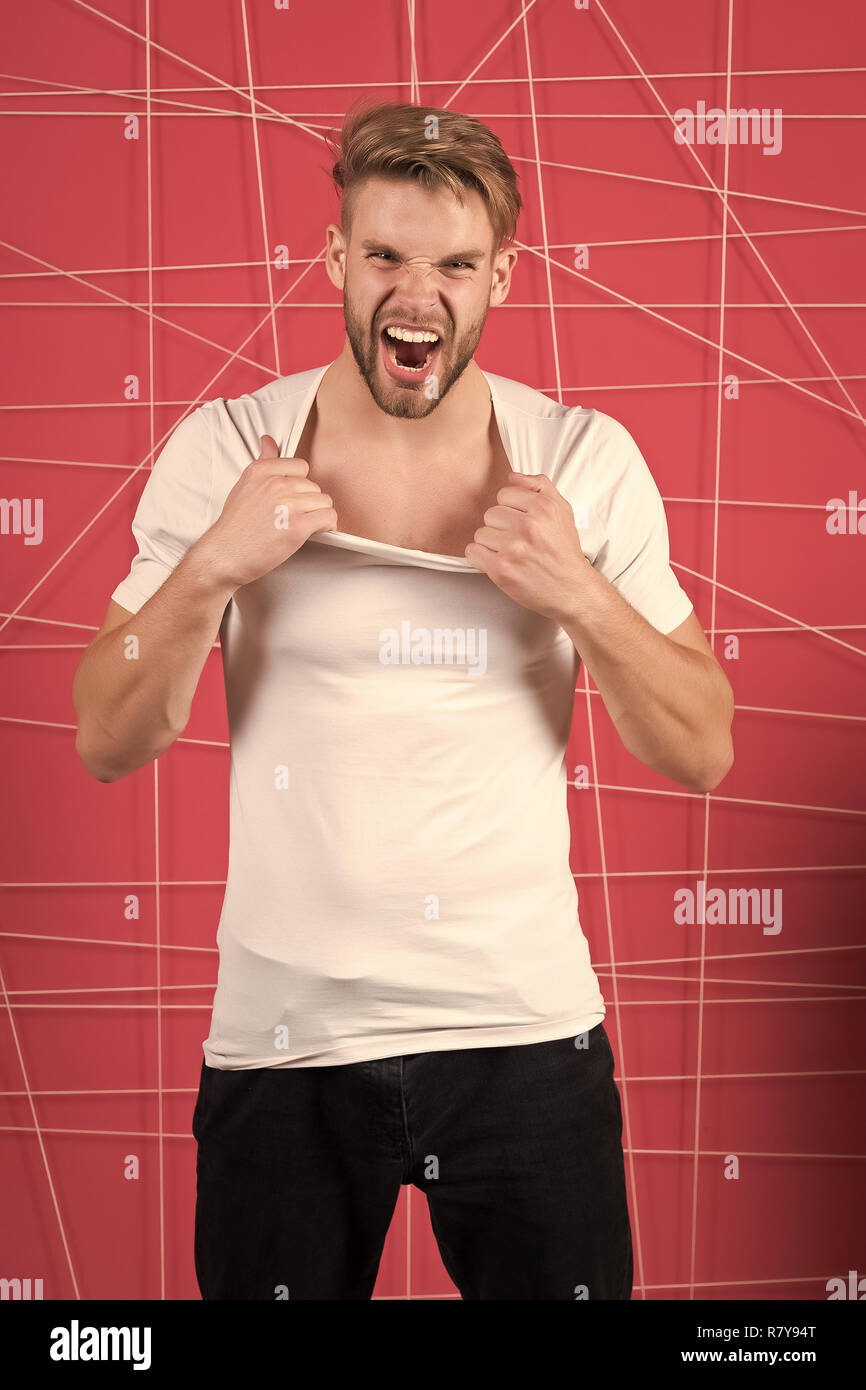 Fashion man pull tshirt collar with anger. Fashion model in casual ...