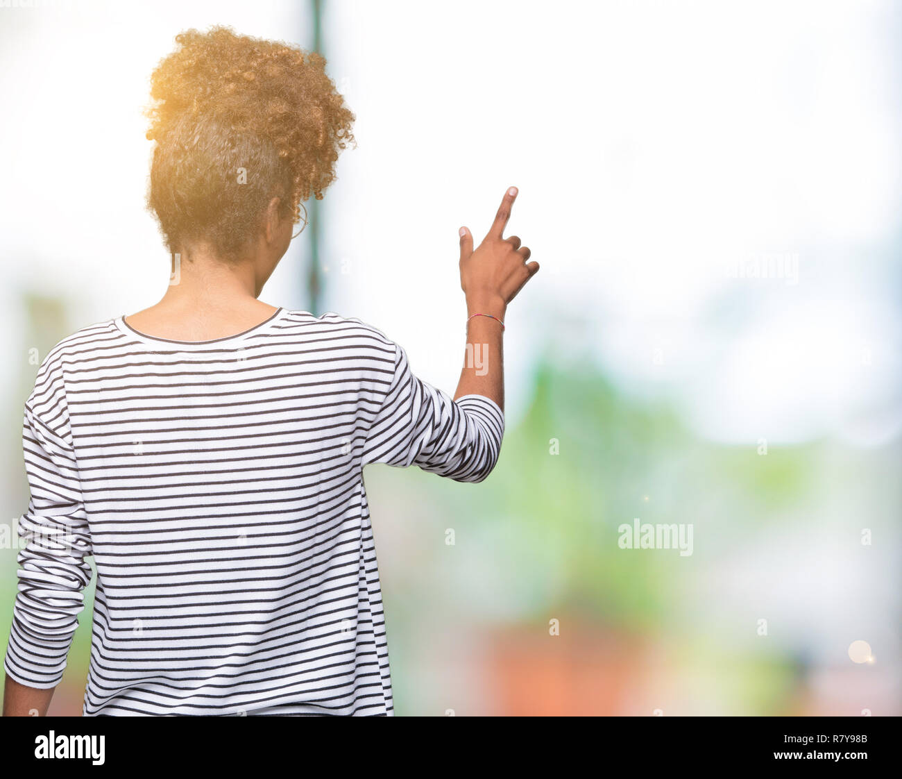Portrait young woman pointing backwards hi-res stock photography and ...