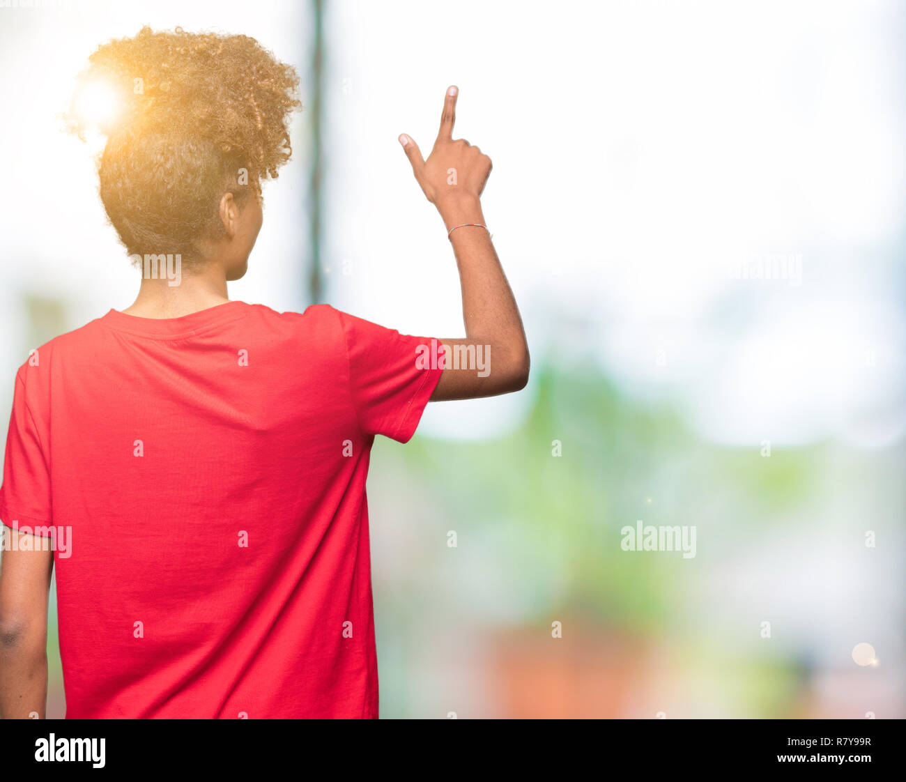 Beautiful young african american woman over isolated background Posing ...