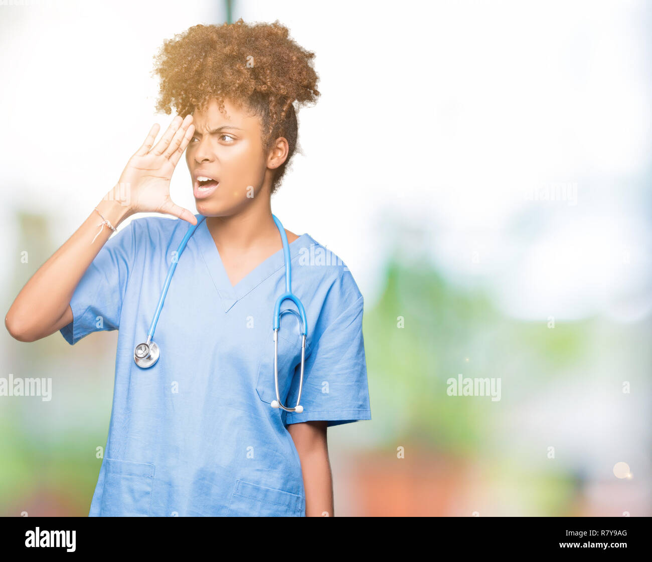 Young african american doctor woman over isolated background shouting ...