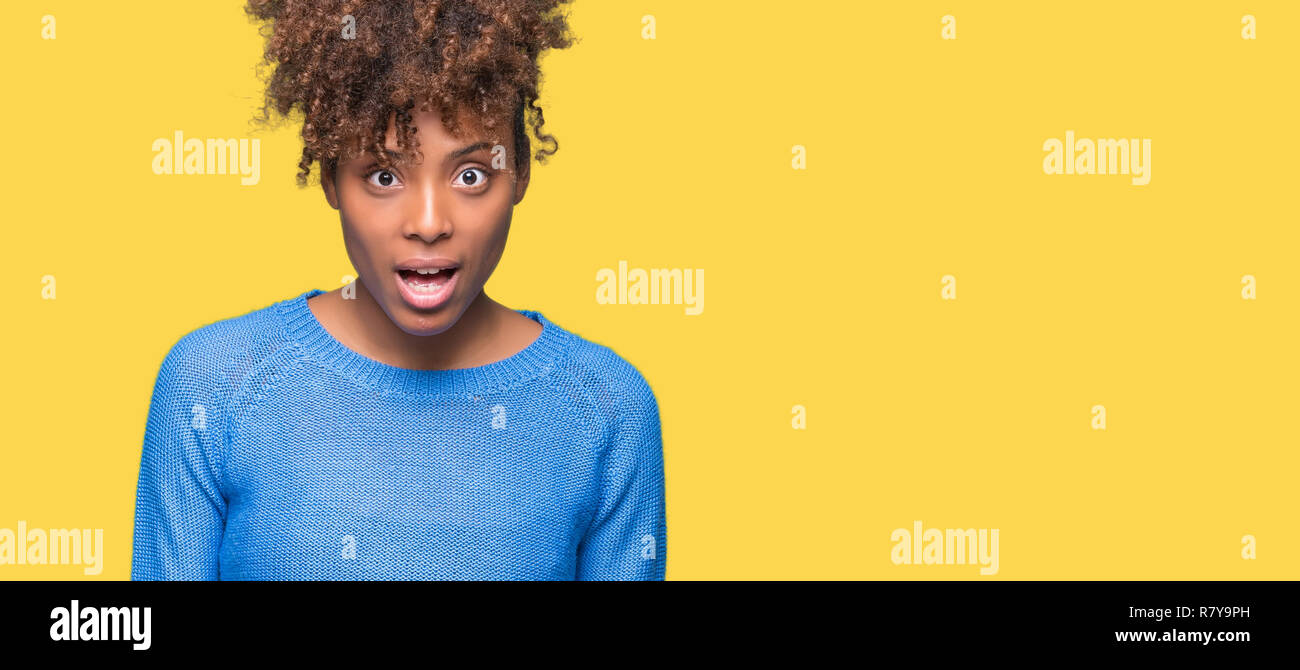 Beautiful young african american woman over isolated background afraid ...