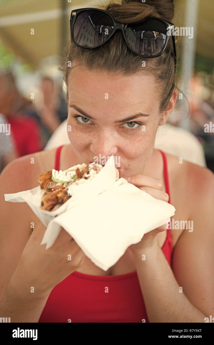 pretty girl or Woman eating sandwich gyros. Girl with pleasure eats ...