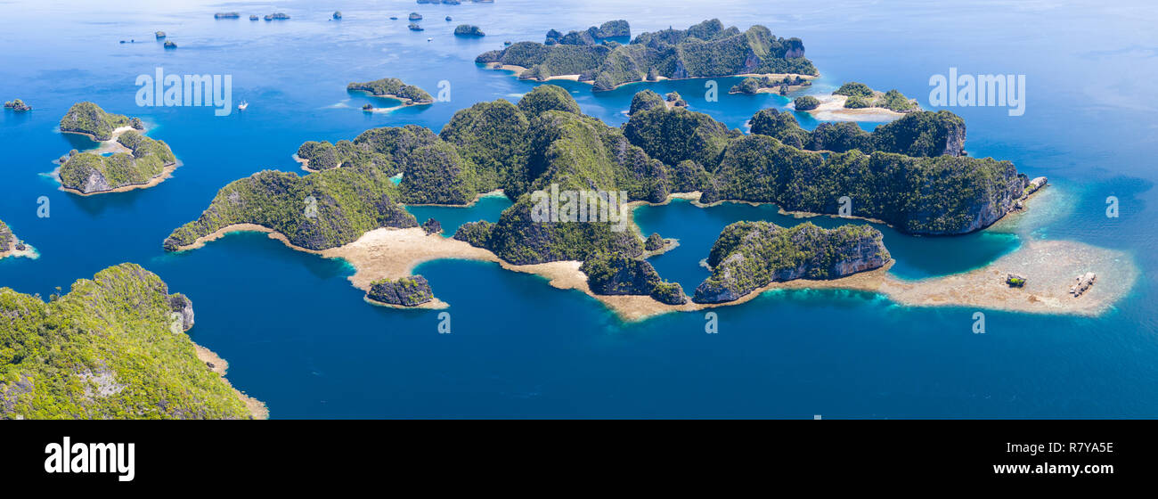 Shallow coral reefs surround remote limestone islands in Raja Ampat ...