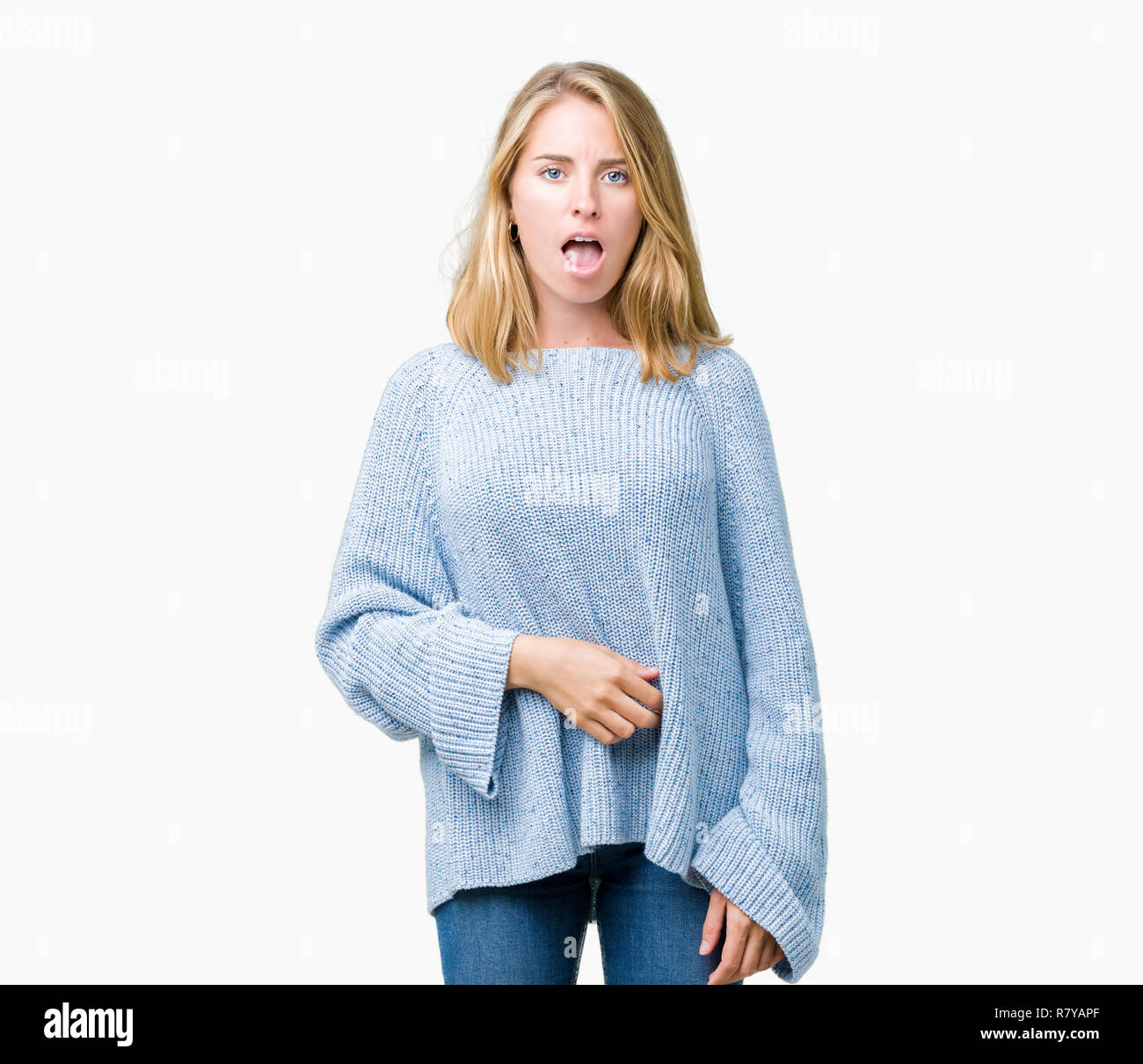 Beautiful young woman wearing blue sweater over isolated background In ...
