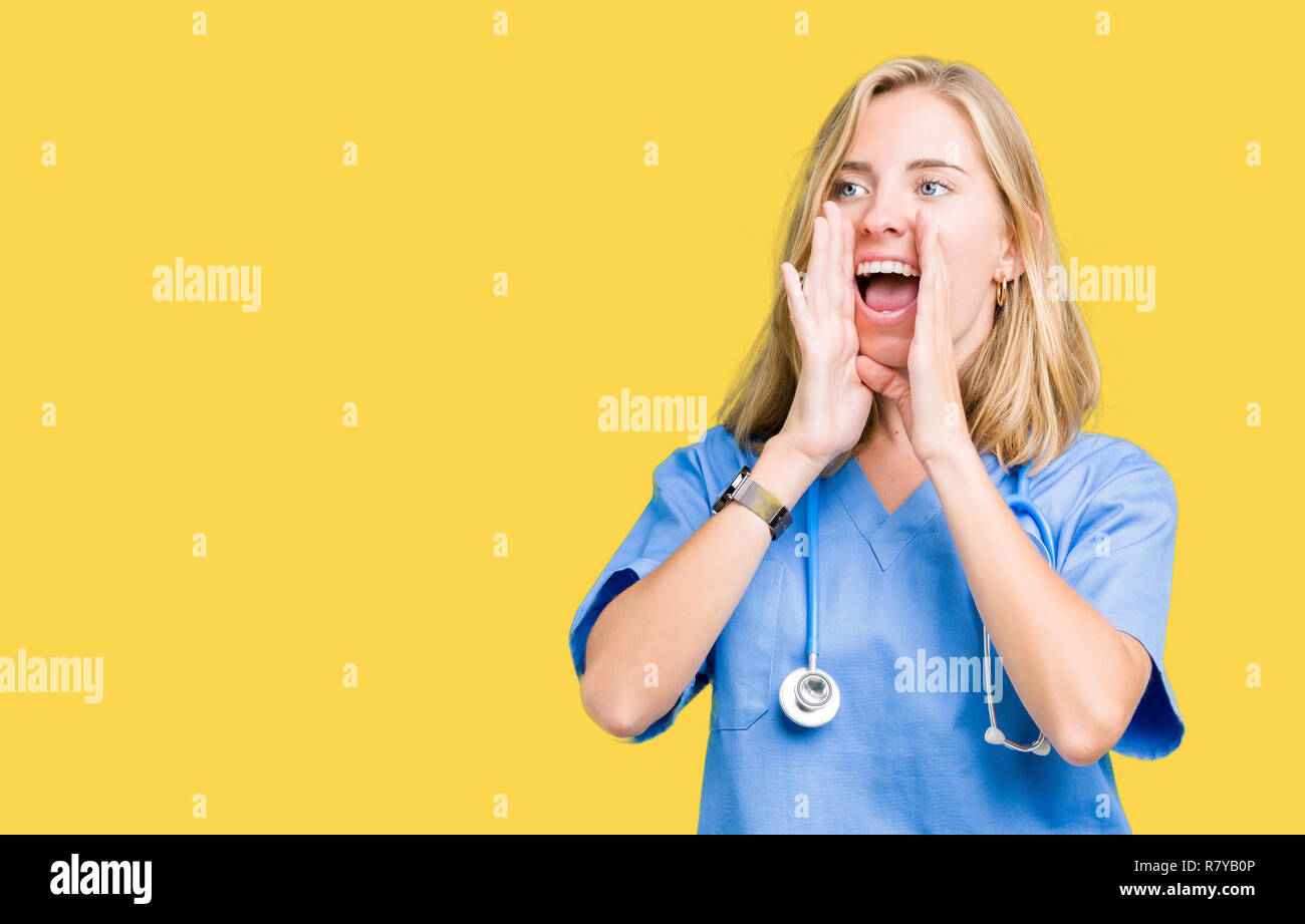 Beautiful young doctor woman wearing medical uniform over isolated ...