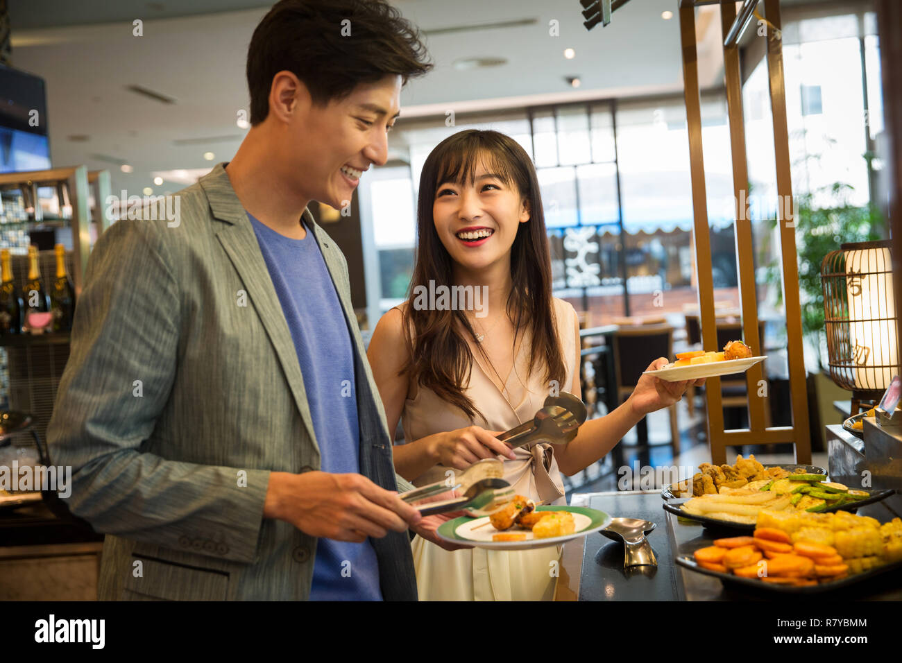 Young couples in the buffet Stock Photo - Alamy