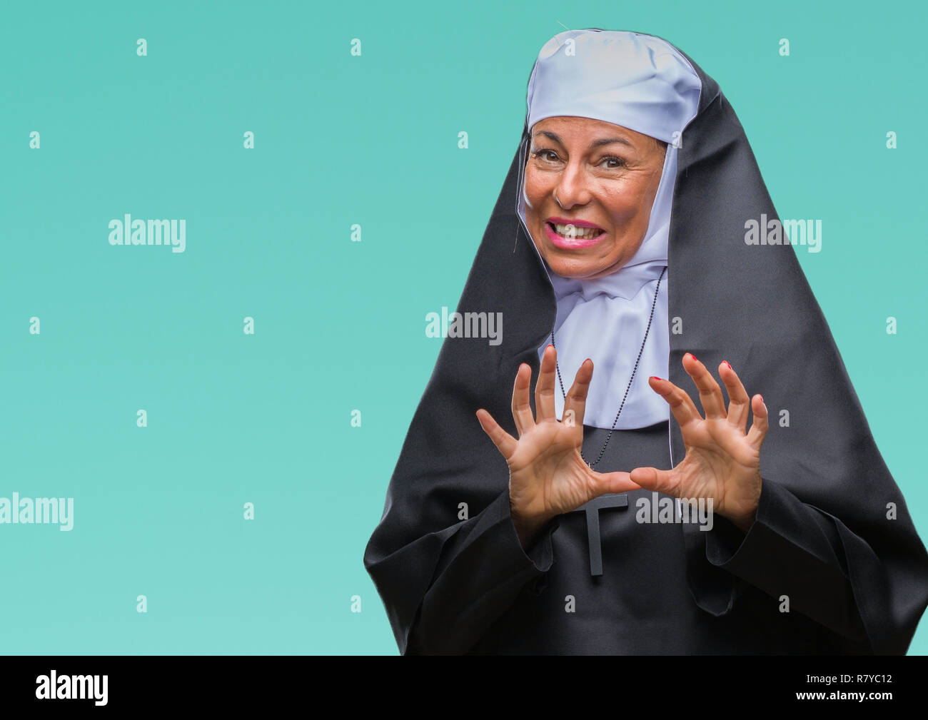 Middle age senior christian catholic nun woman over isolated background ...