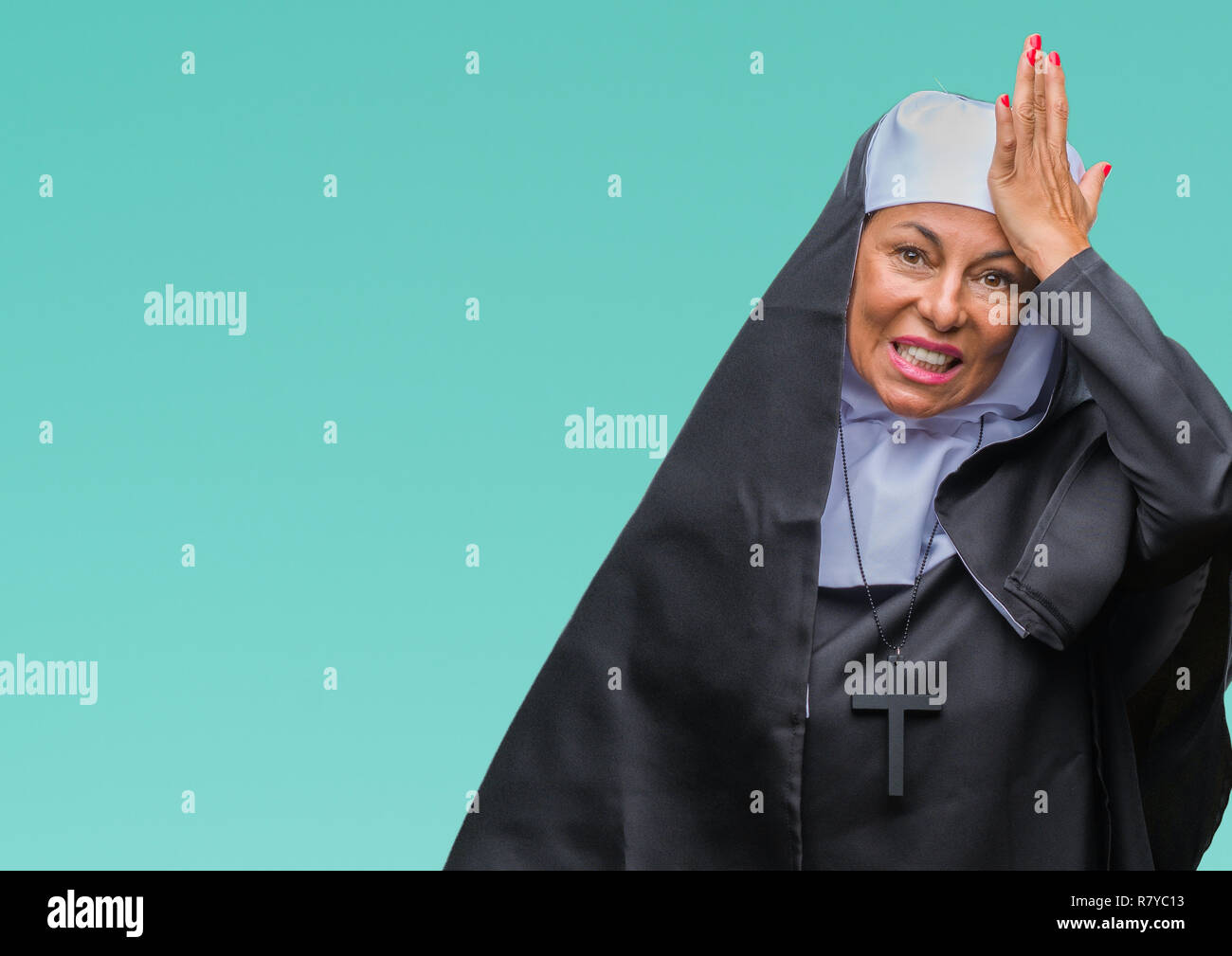 Middle age senior christian catholic nun woman over isolated background ...