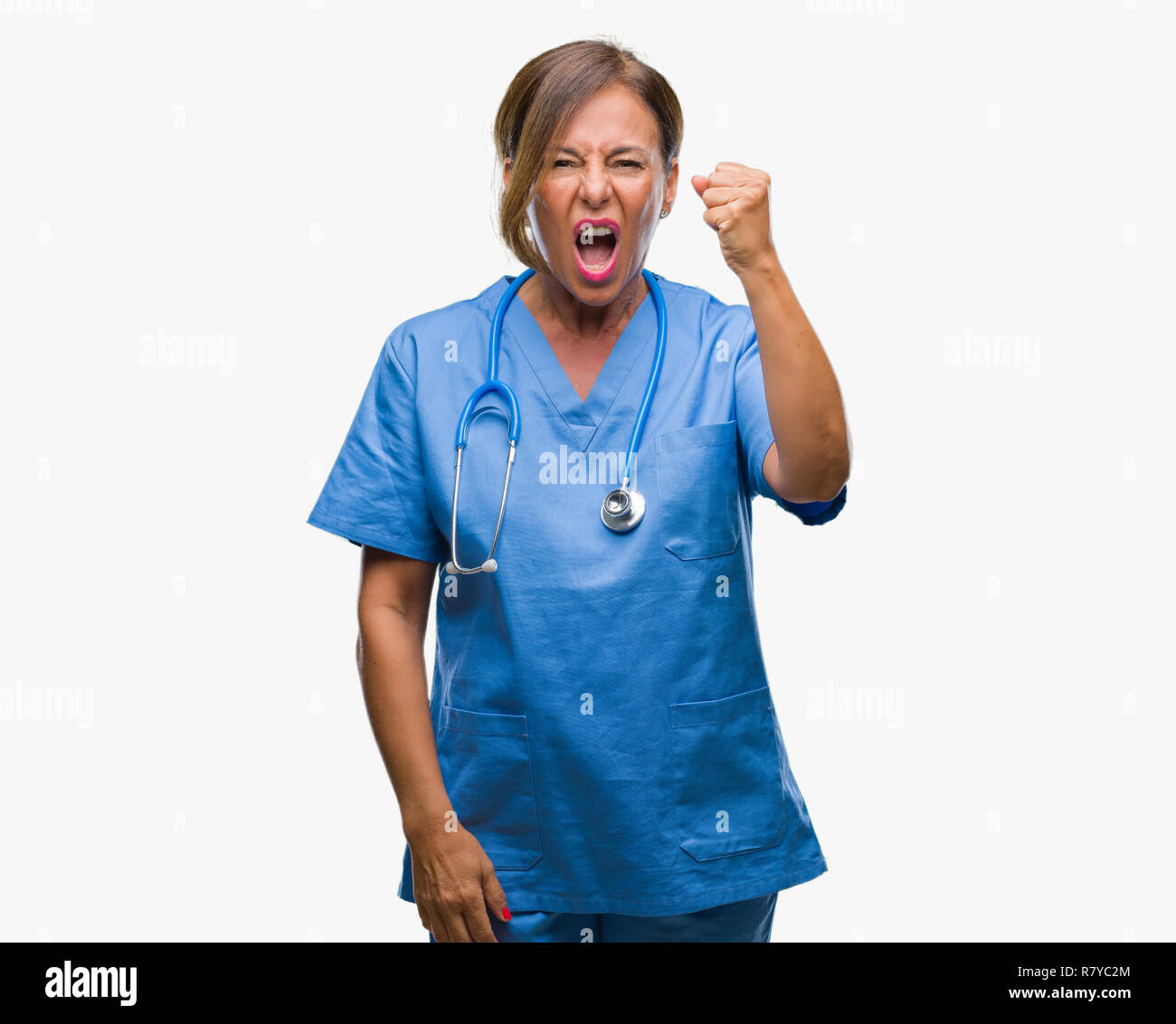 Middle age senior nurse doctor woman over isolated background angry and ...