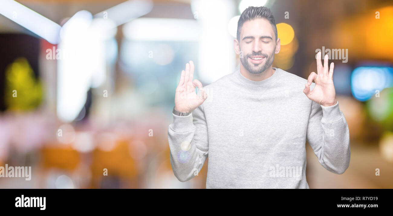 Young handsome man wearing sweatshirt over isolated background relax ...