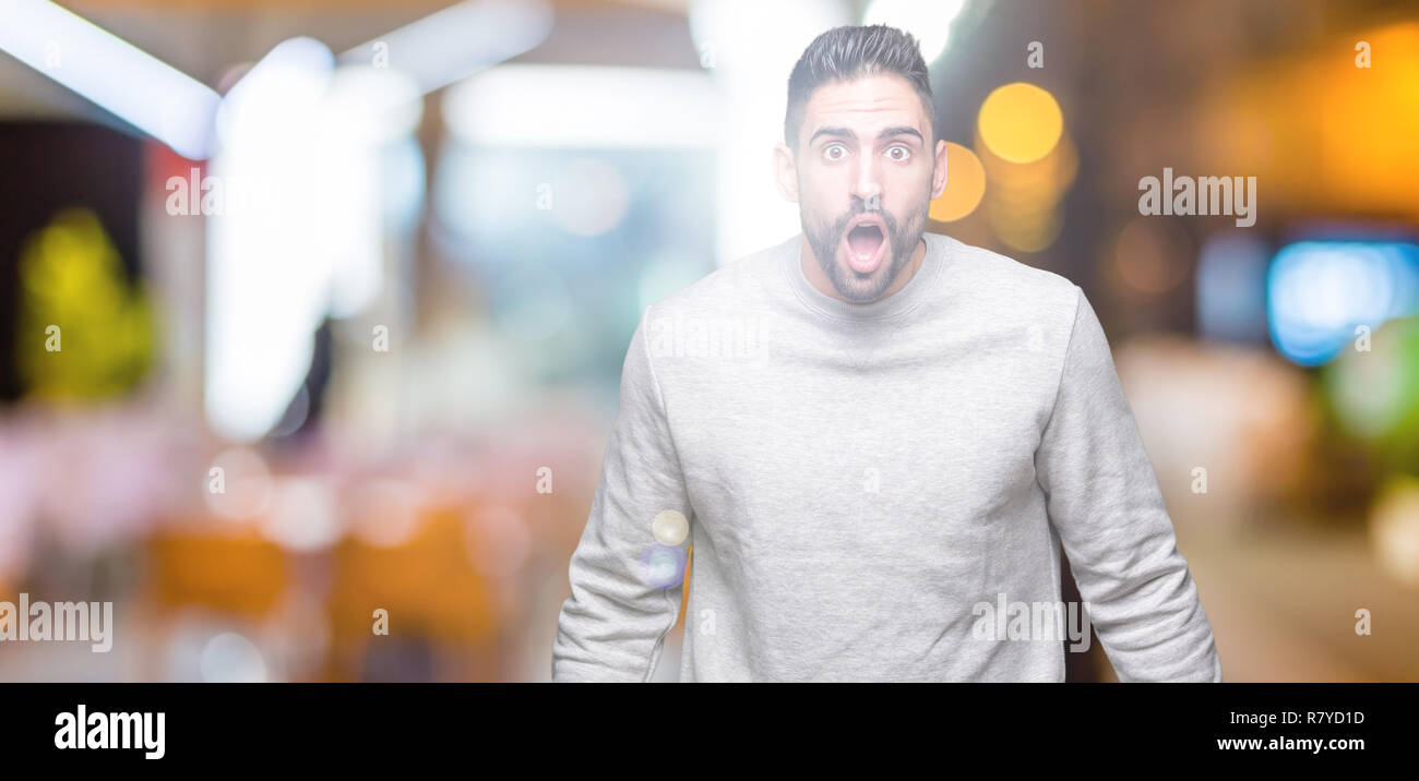 Young handsome man wearing sweatshirt over isolated background In shock ...