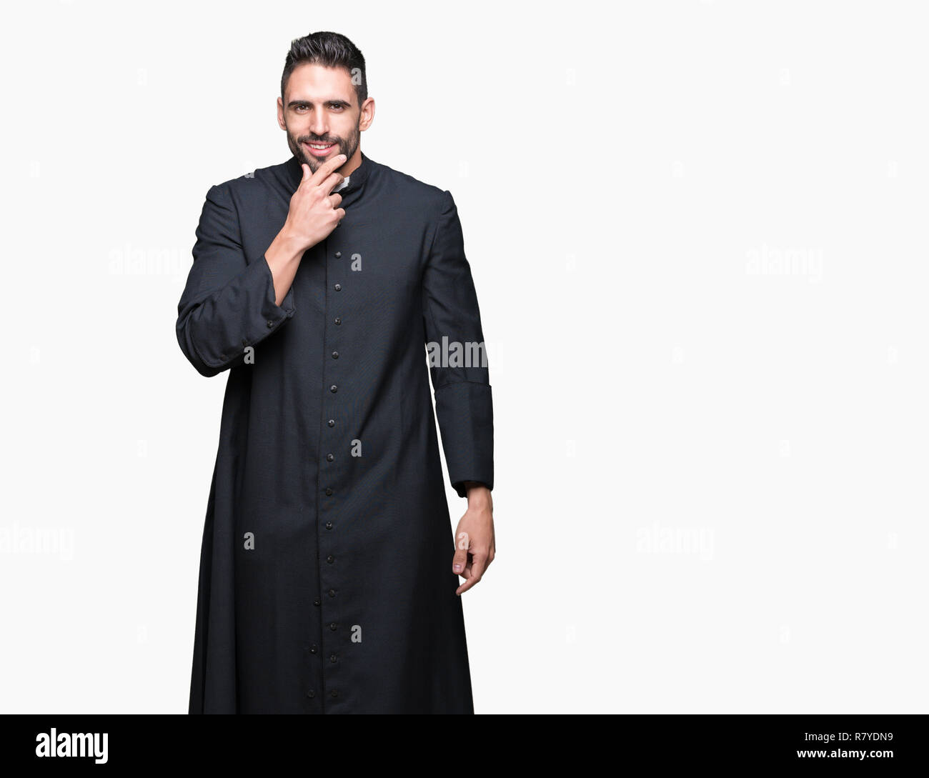 Young Christian priest over isolated background looking confident at ...