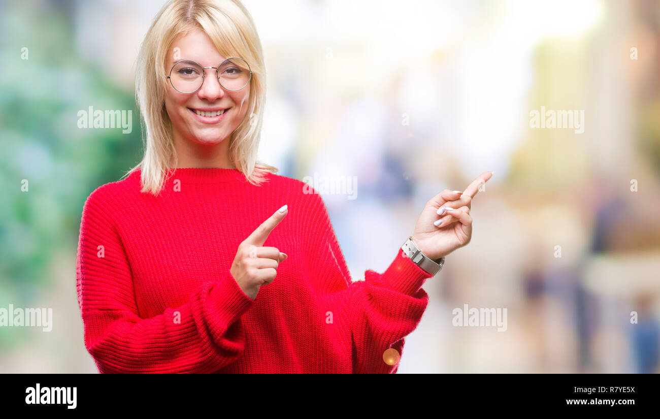 Young beautiful blonde woman wearing sweater and glasses over isolated ...