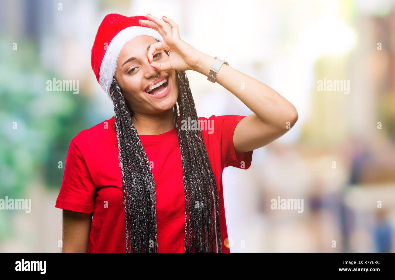 Young braided hair african american girl wearing christmas hat over ...
