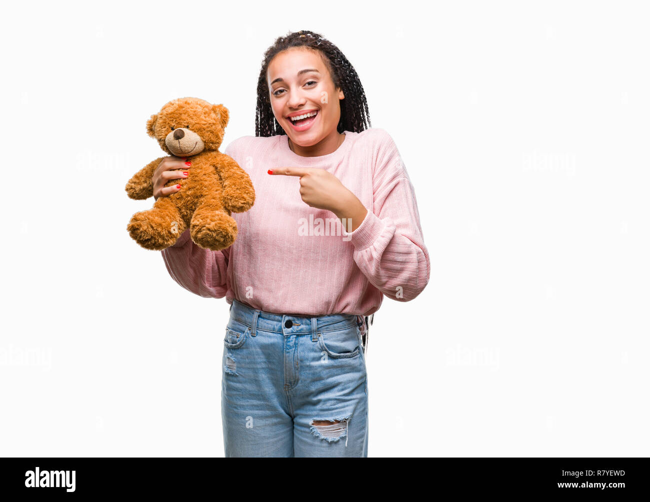 Young african american girl holding teddy bear over isolated background ...