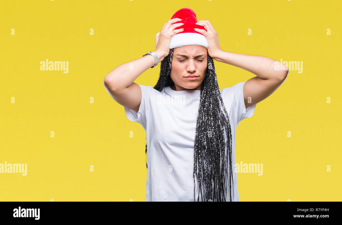 Young braided hair african american girl wearing christmas hat over ...