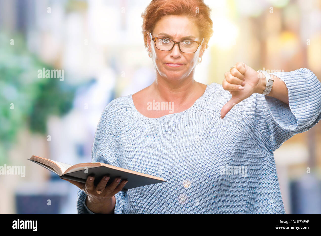 Senior caucasian woman reading a book over isolated background with ...