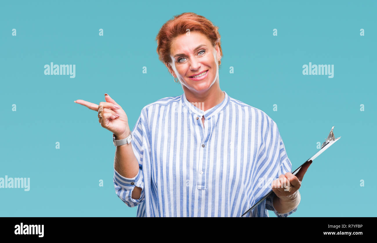 Senior caucasian business woman holding clipboard over isolated ...