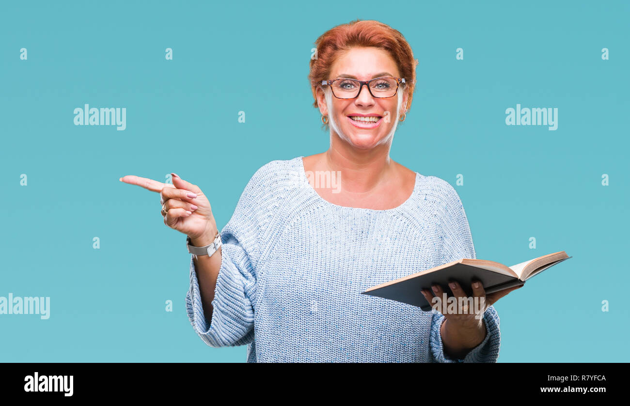 Senior caucasian woman reading a book over isolated background very ...