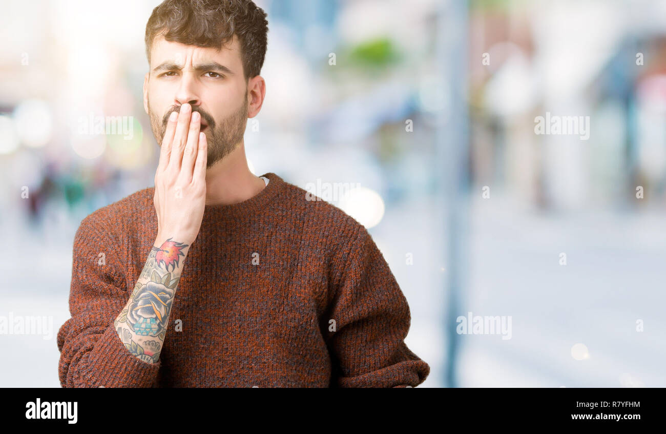 Young handsome man wearing winter sweater over isolated background ...