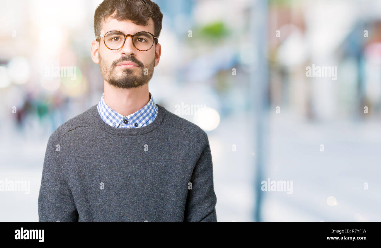 Young handsome smart man wearing glasses over isolated background ...