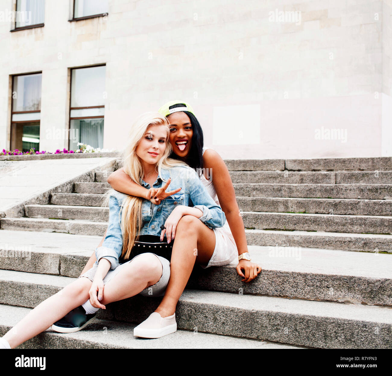 Two teenage girls infront of university building smiling, having Stock ...