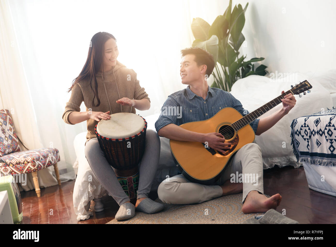 Happy couples playing Musical Instruments at home Stock Photo - Alamy