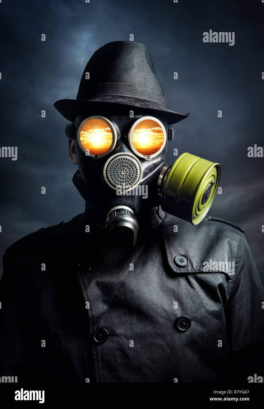 Man in gas mask with explosion in his eyes at dark sky background Stock ...