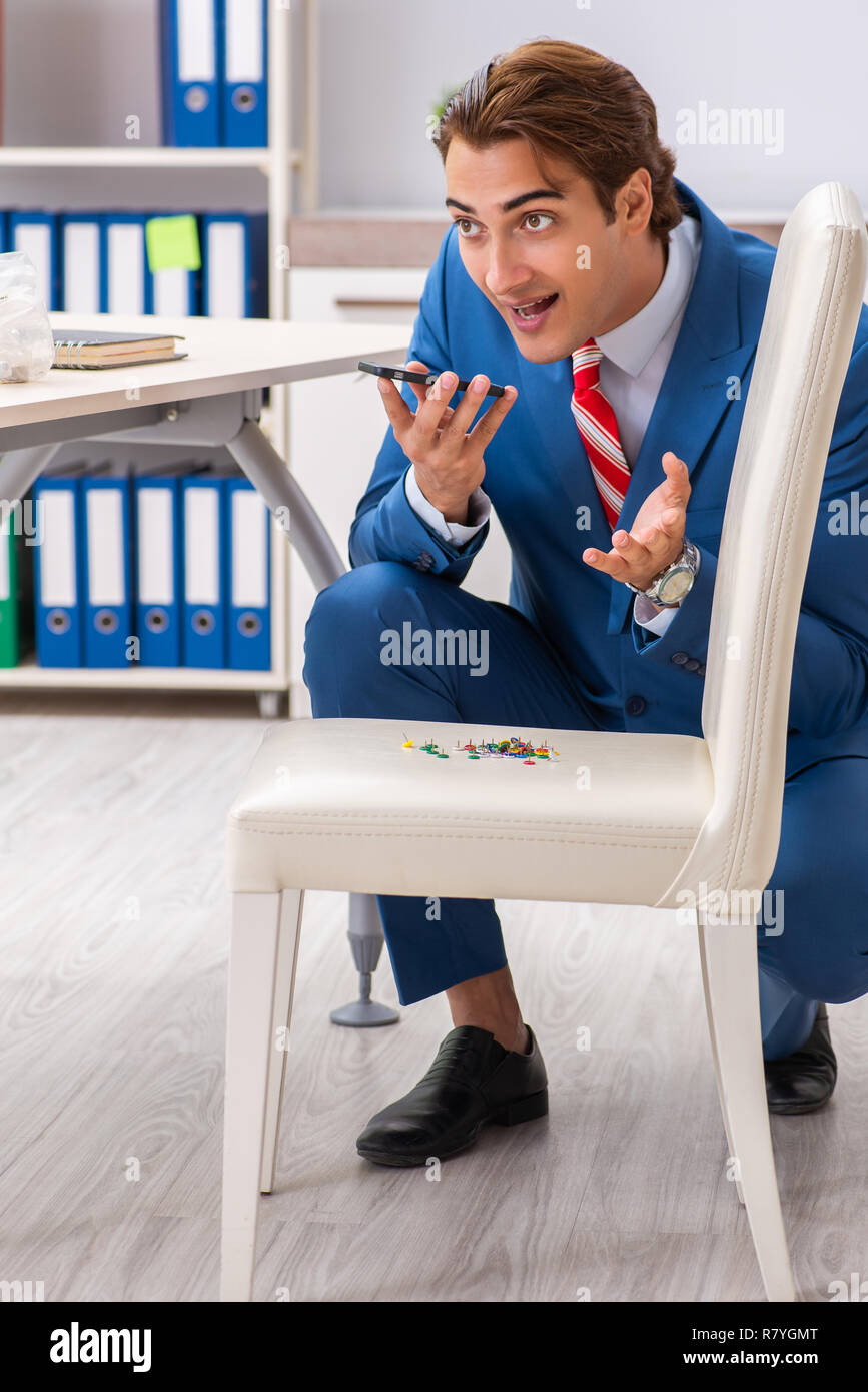 Office prank with sharp thumbtacks on chair Stock Photo - Alamy