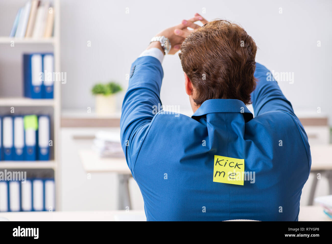 Office prank with kick me message on sticky note Stock Photo - Alamy