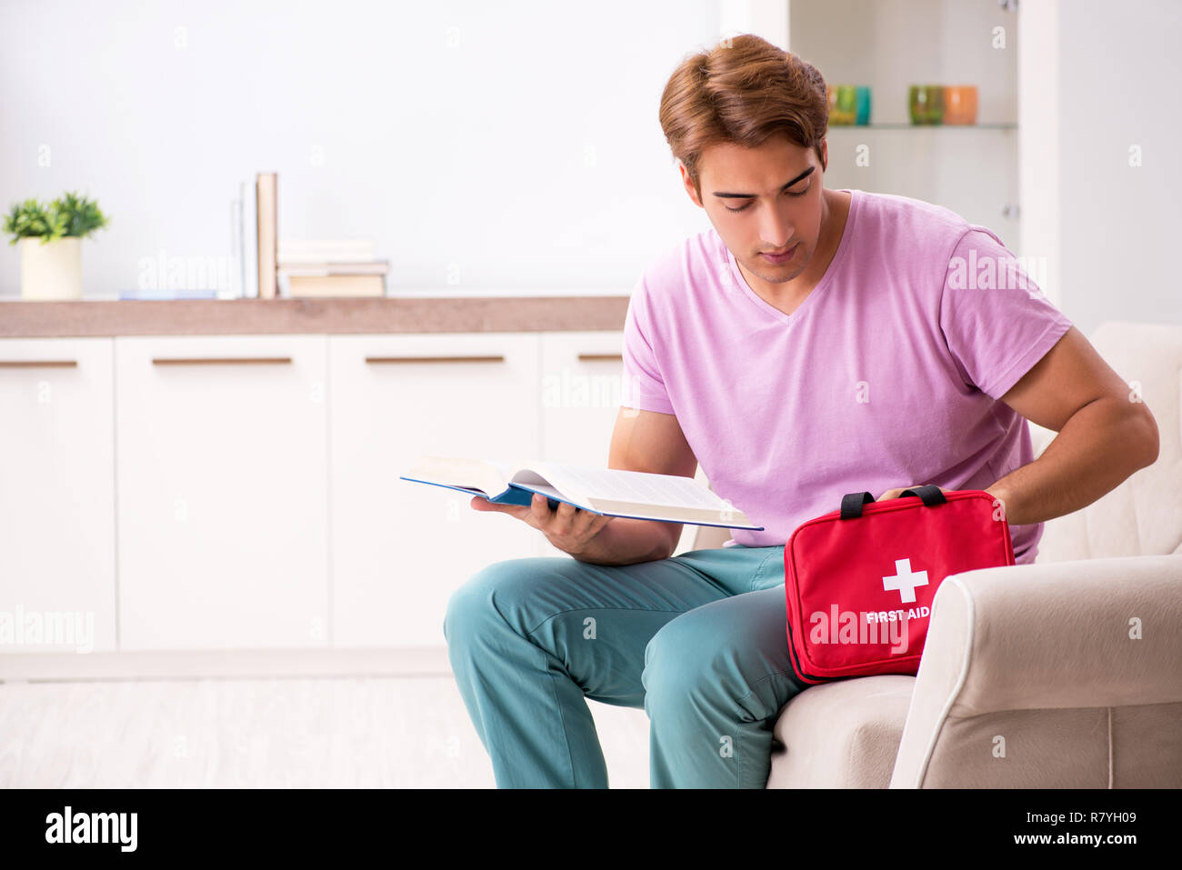 Sick man at home with first aid kit Stock Photo - Alamy