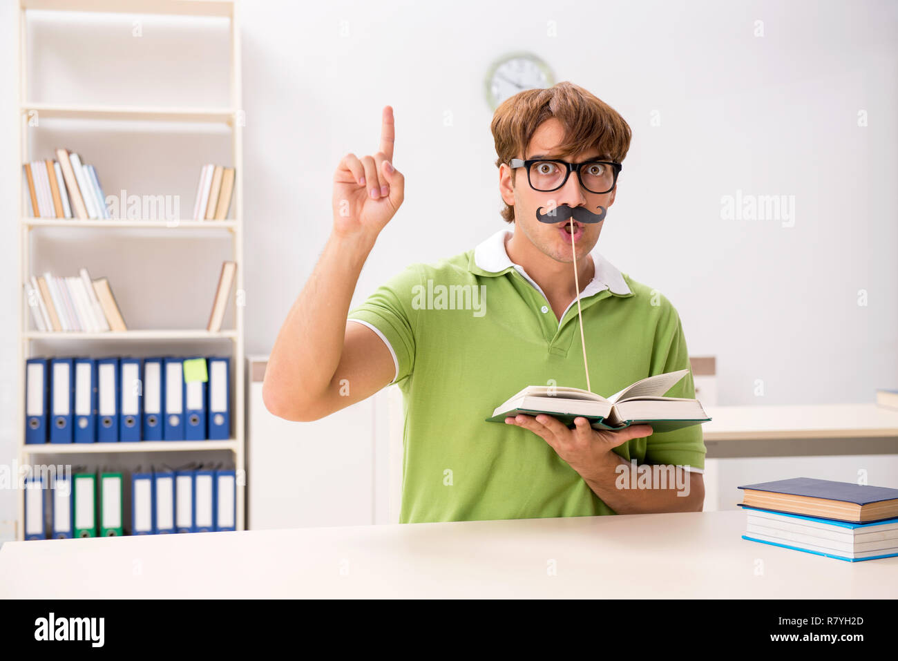 Student with fake moustache reading book Stock Photo - Alamy