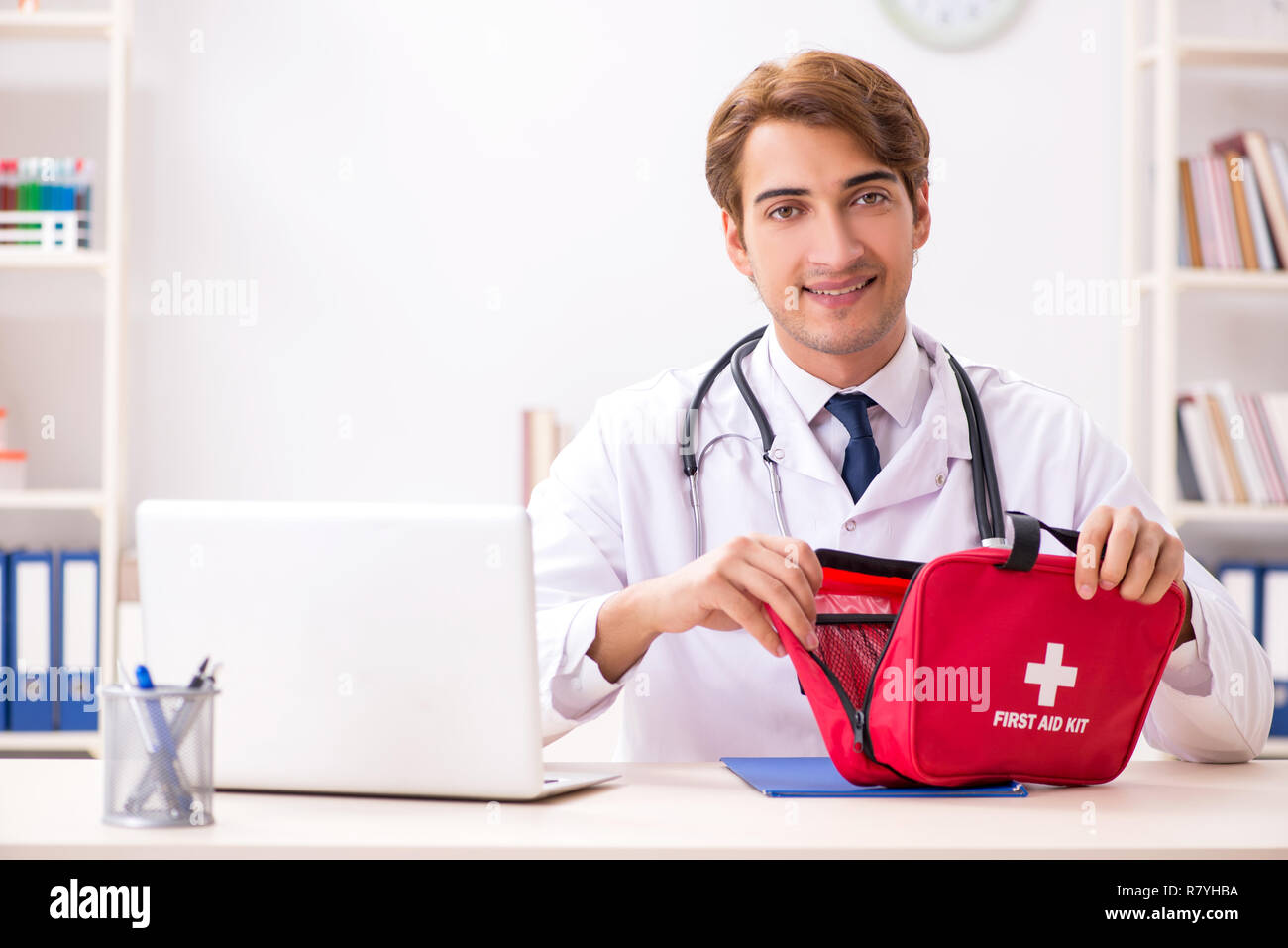 Young doctor with first aid kit in hospital Stock Photo - Alamy