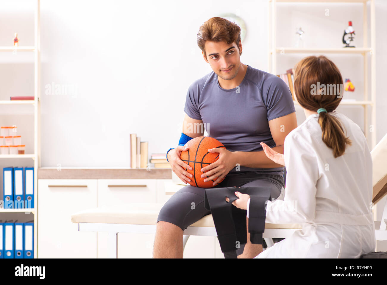 Handsome basketball player visiting female doctor traumatologist Stock ...