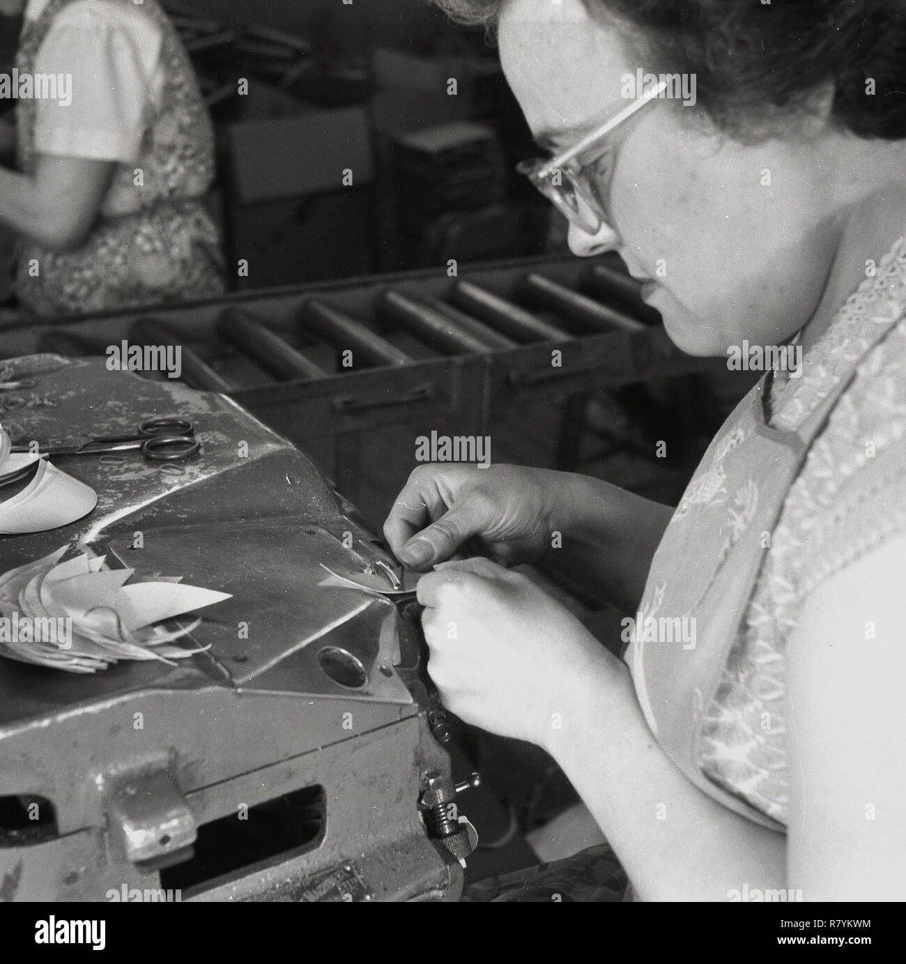 1950s, historical, shoe manfacturing, an adult female worker making ...