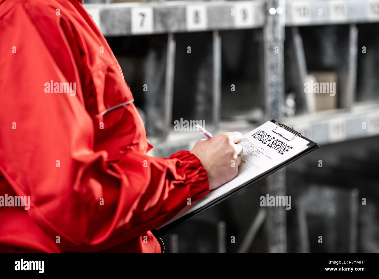 Worker filling some documents in the warehouse, close-up view Stock ...